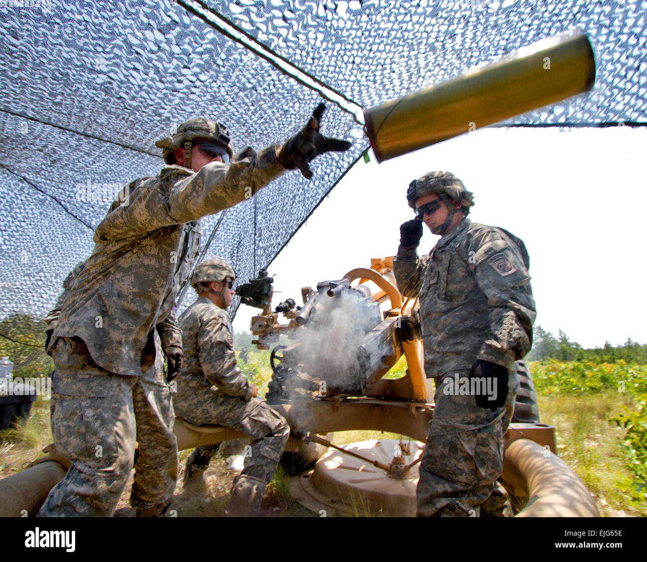 U.S. Army Sgt. Adam Phillips tosses an empty canister from an M119A2 ...