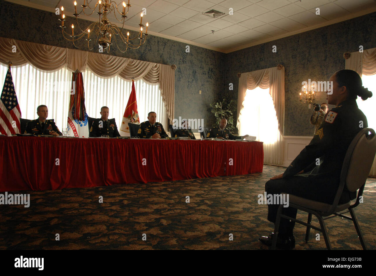 Sgt. Lauren Aldaco, 217th Military Police Detachment, sits and answers ...