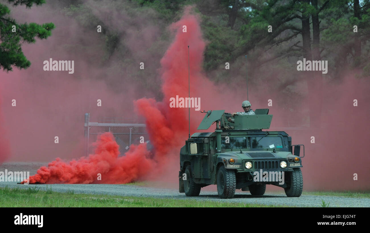 A Humvee rolls through a smoke screen during convoy lanes training ...