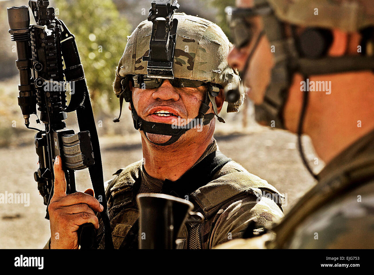 U.S. Army Spc. John "Rocky" Montoya talks to the convoy commander about ...