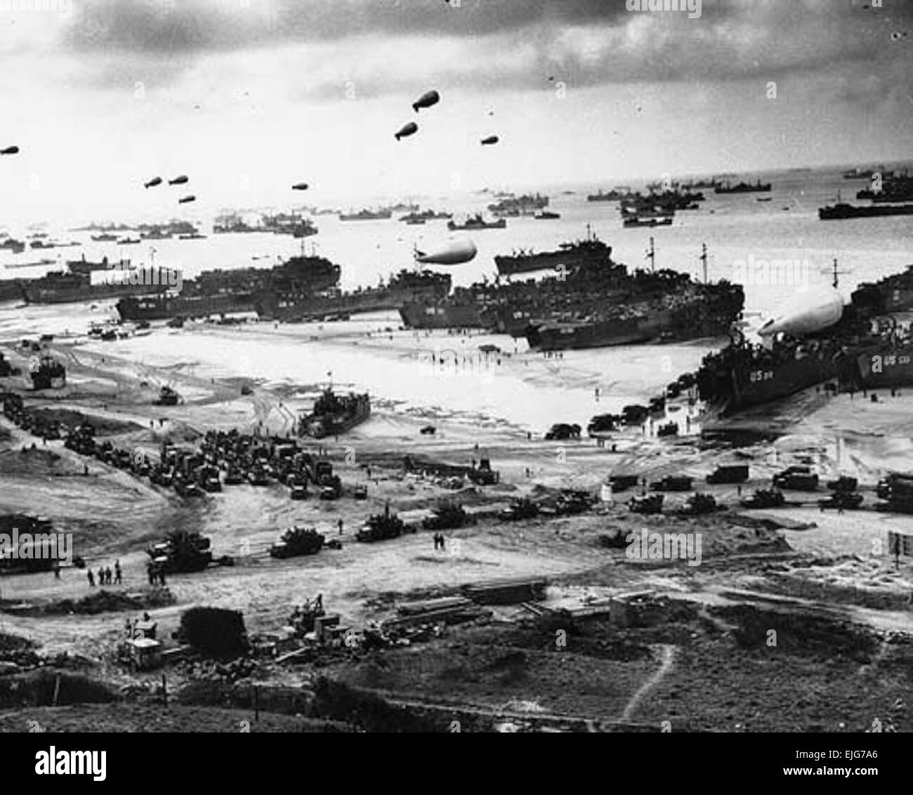 Soldiers in cargo vehicles move onto a beach in Normandy during the ...