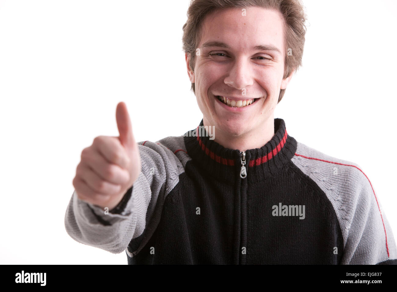 thumbs up by young man smiling Stock Photo - Alamy