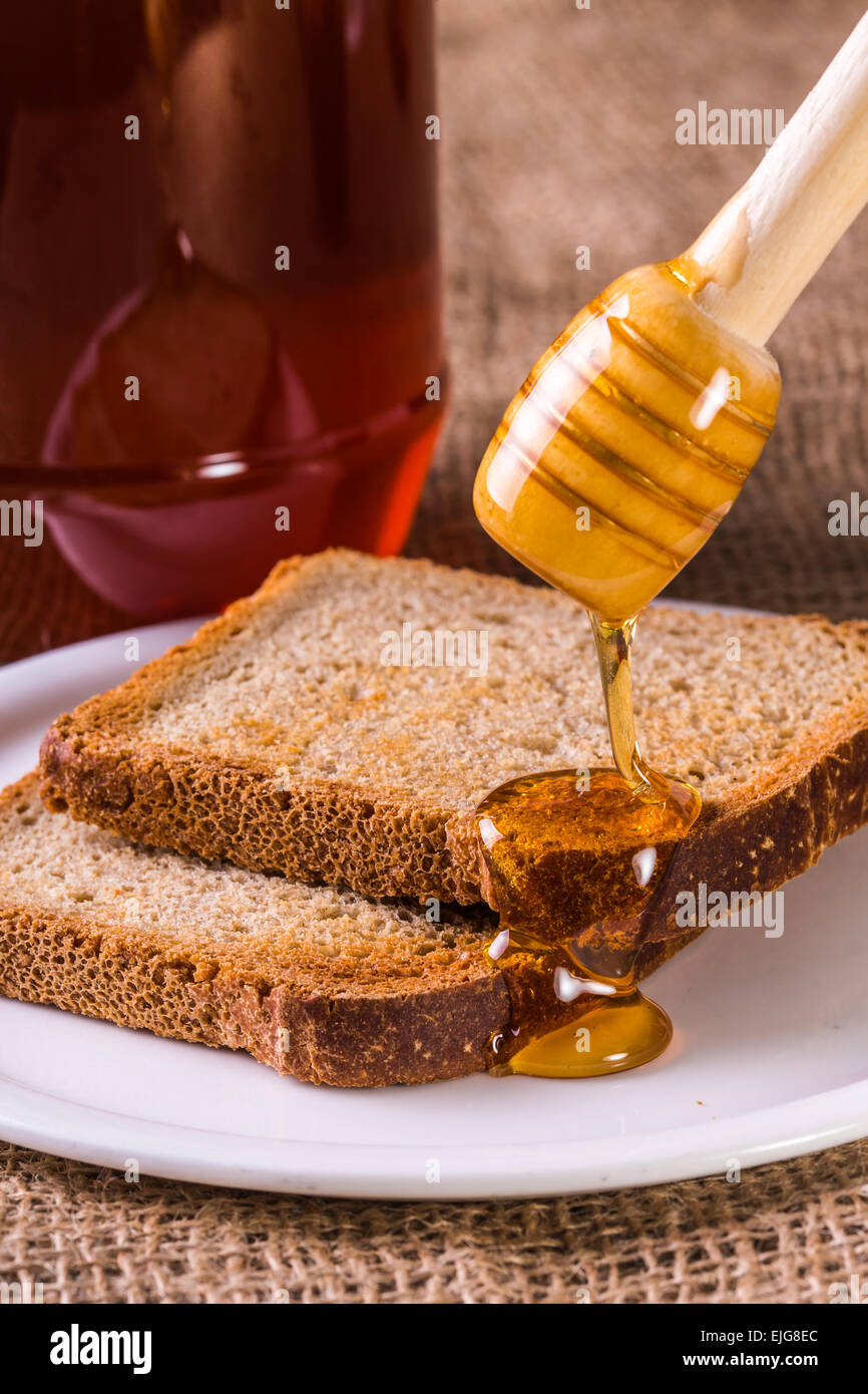 fresh toast with honey poured on vintage background Stock Photo - Alamy