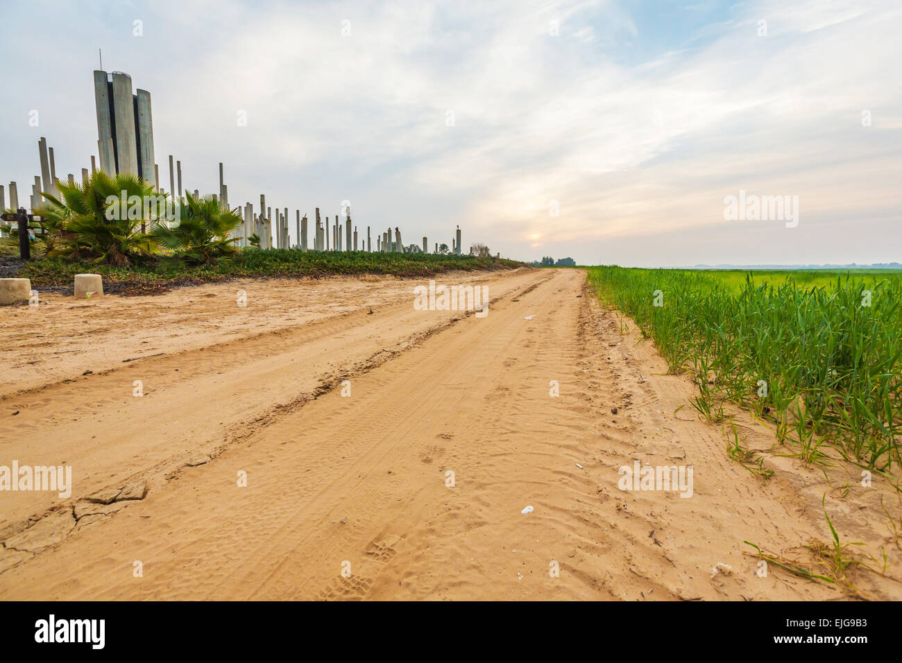 sandy road in a rural against a blue sky Stock Photo - Alamy