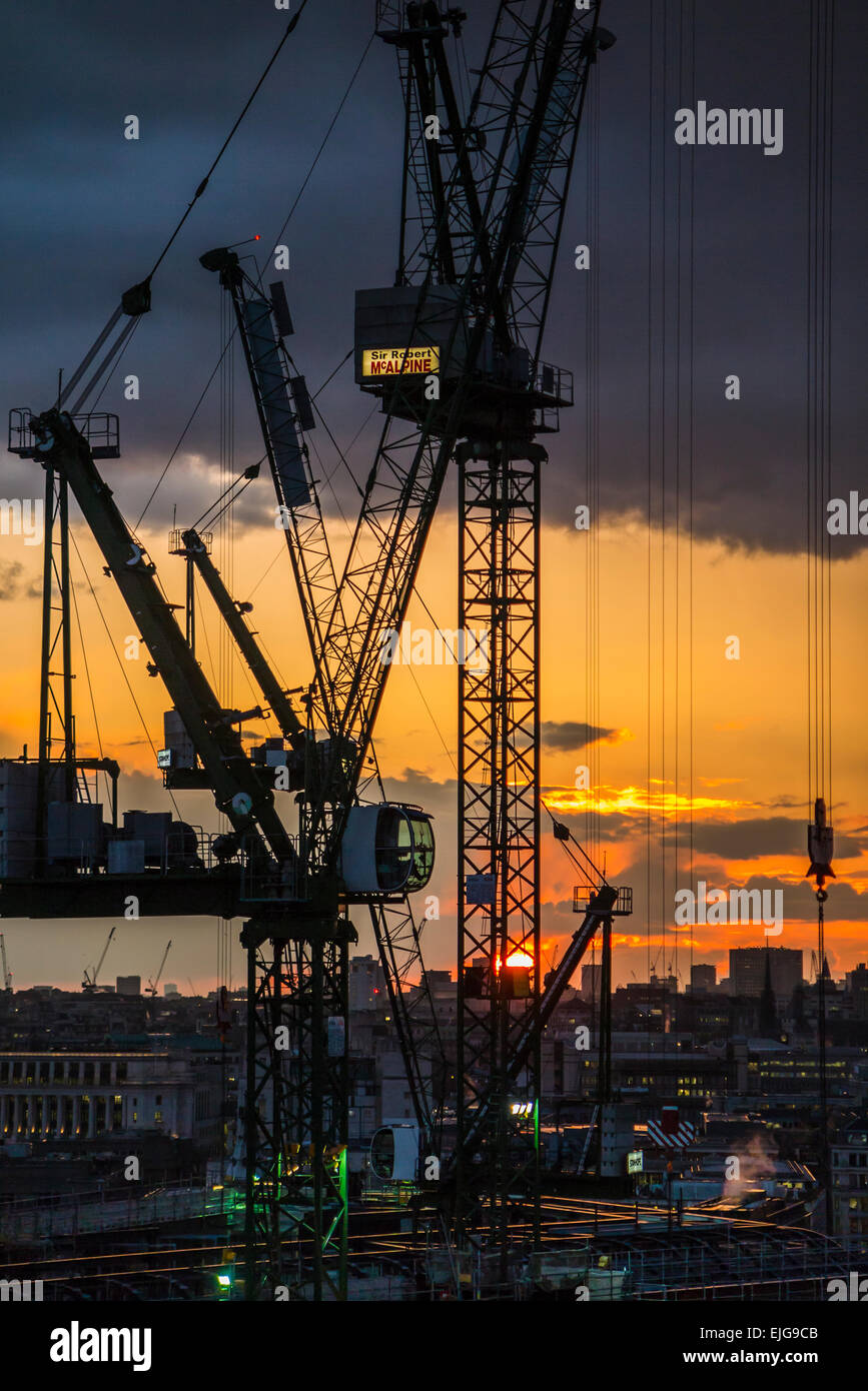 Silhouetted cranes over the Bloomberg Place construction site, London ...