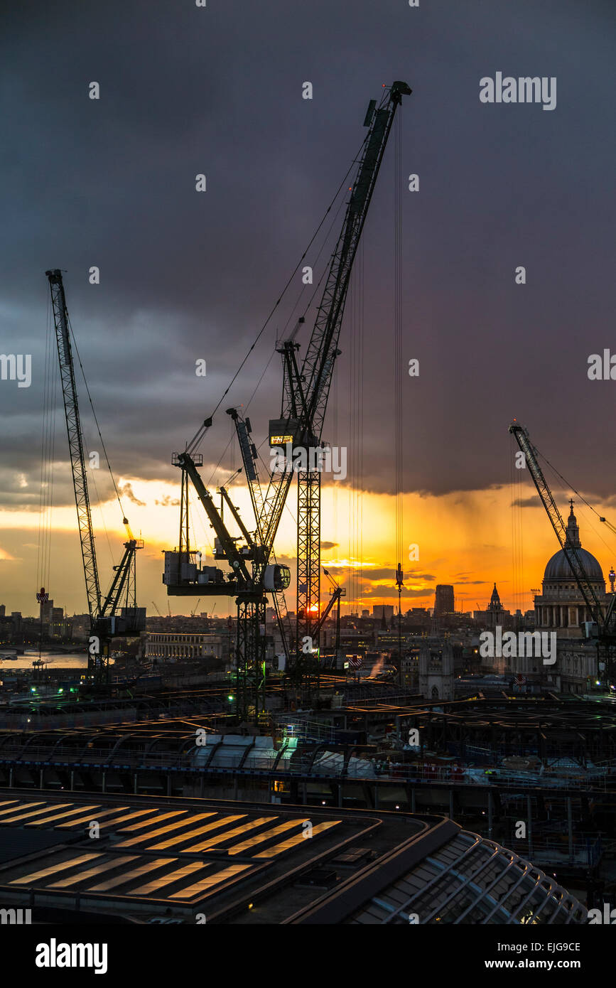 Silhouetted cranes over the Bloomberg Place construction site, London ...