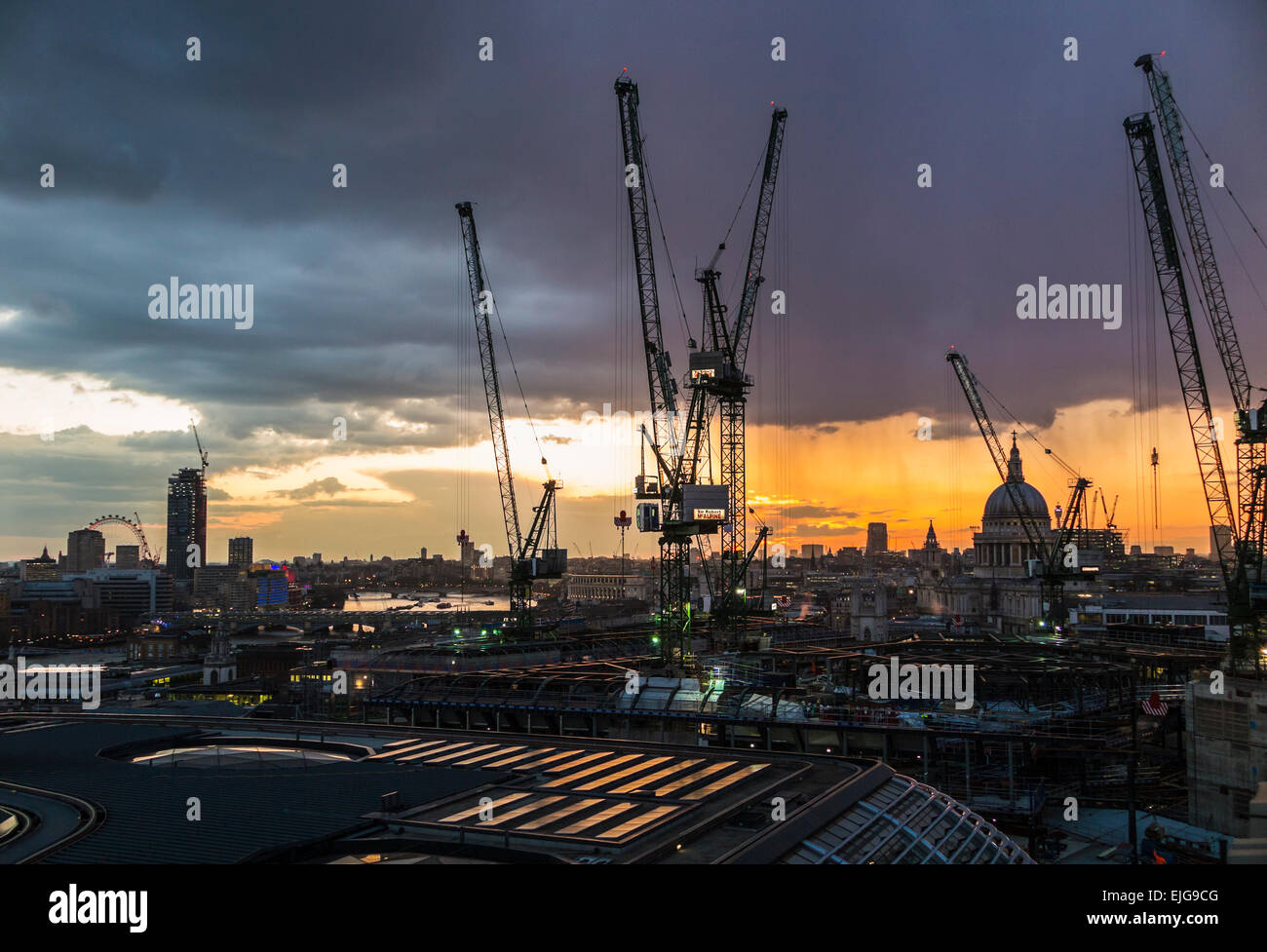 Cityscape of silhouetted cranes on the Bloomberg Place construction ...