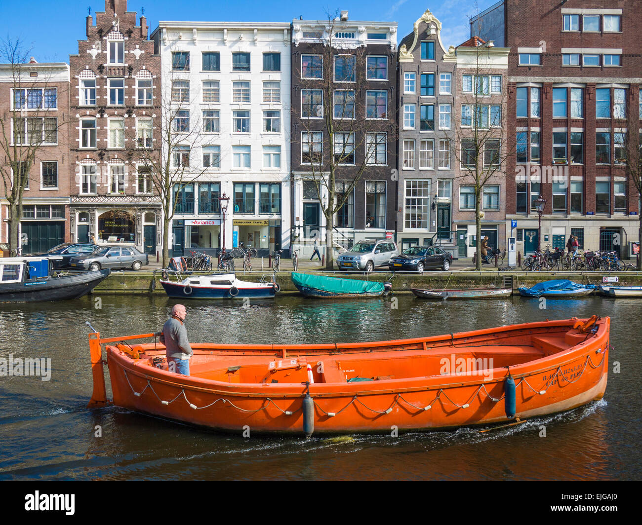 A working boat passing on the Singel Canal, Amsterdam, Netherlands ...