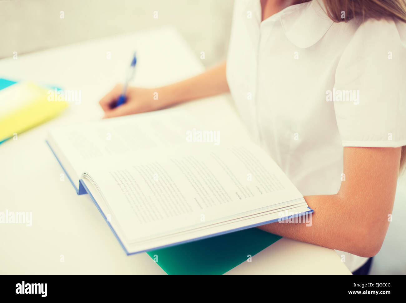 student girl writing in notebook at school Stock Photo - Alamy