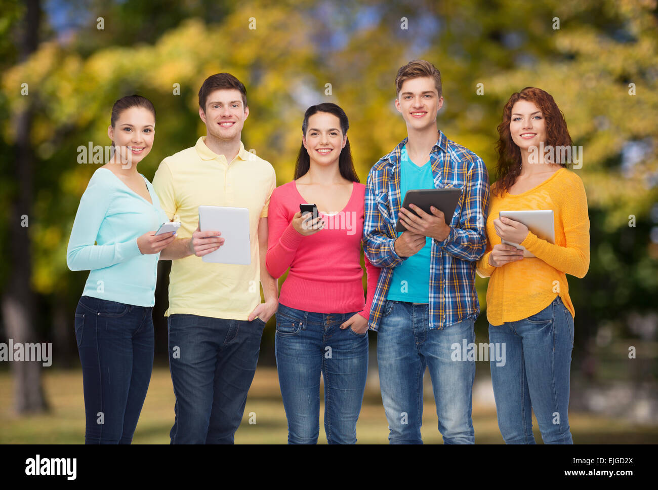 group of teenagers with smartphones and tablet pc Stock Photo - Alamy
