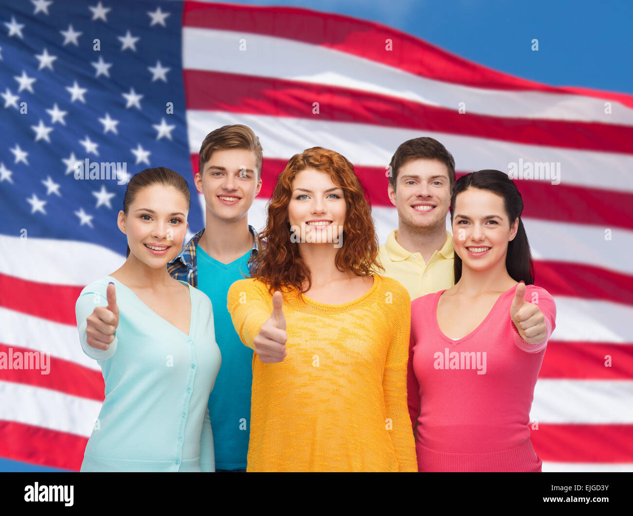 group of smiling teenagers over american flag Stock Photo - Alamy