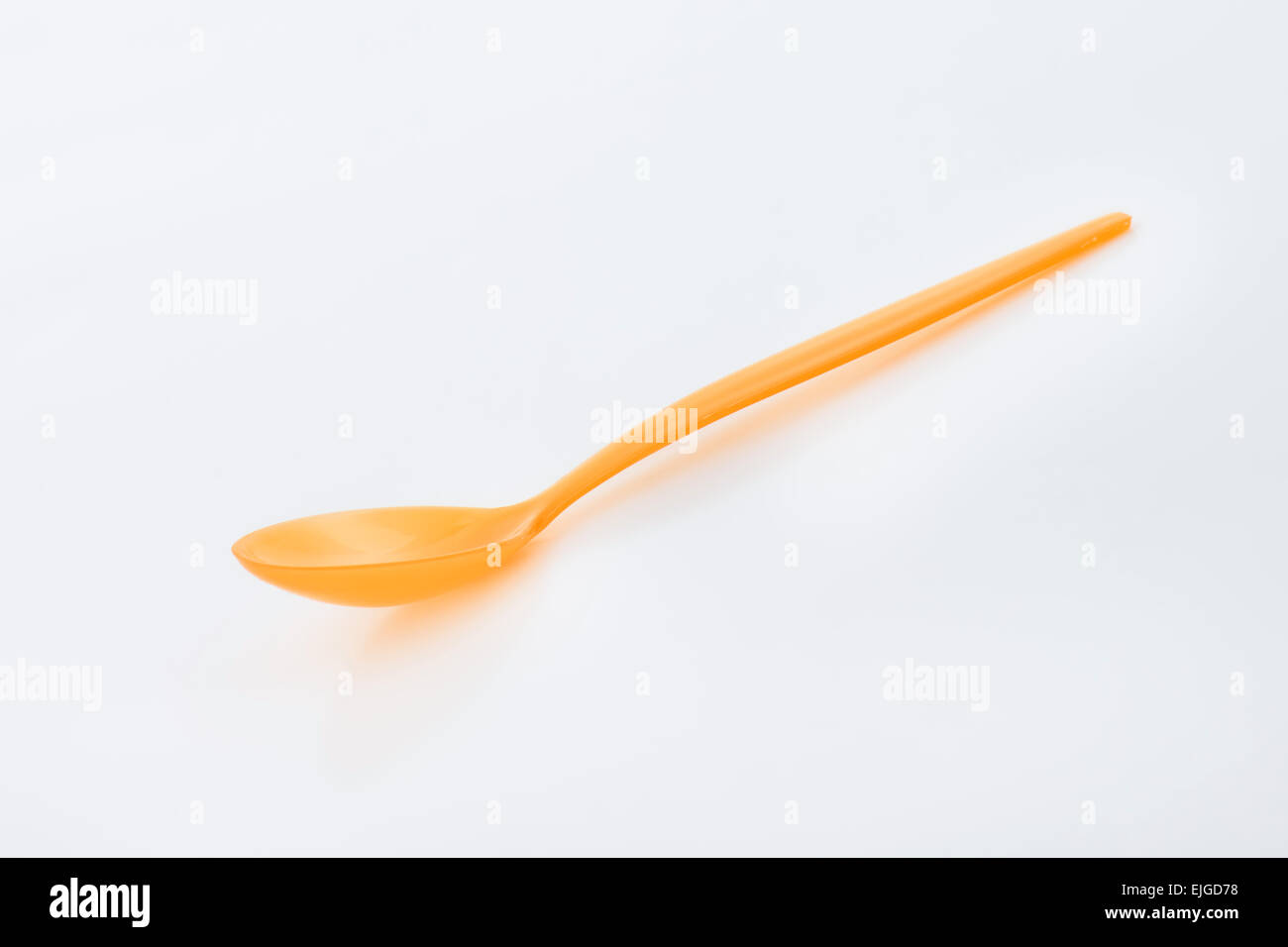 Orange plastic spoon for daily use Stock Photo - Alamy