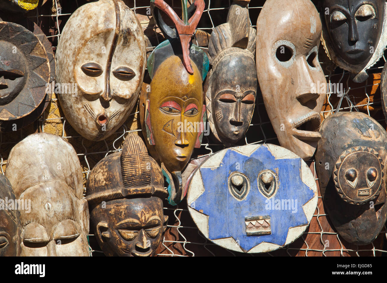 Traditional african masks hanging for sell in a market stall Stock ...