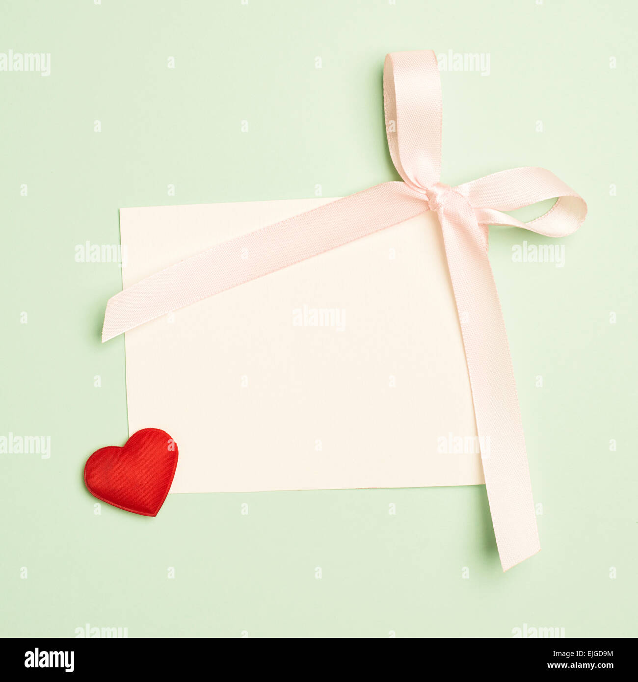 Empty greeting card over a mint green background Stock Photo - Alamy