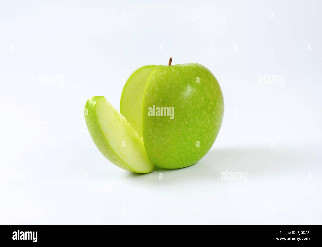 Green apple - a wedge cut off Stock Photo - Alamy