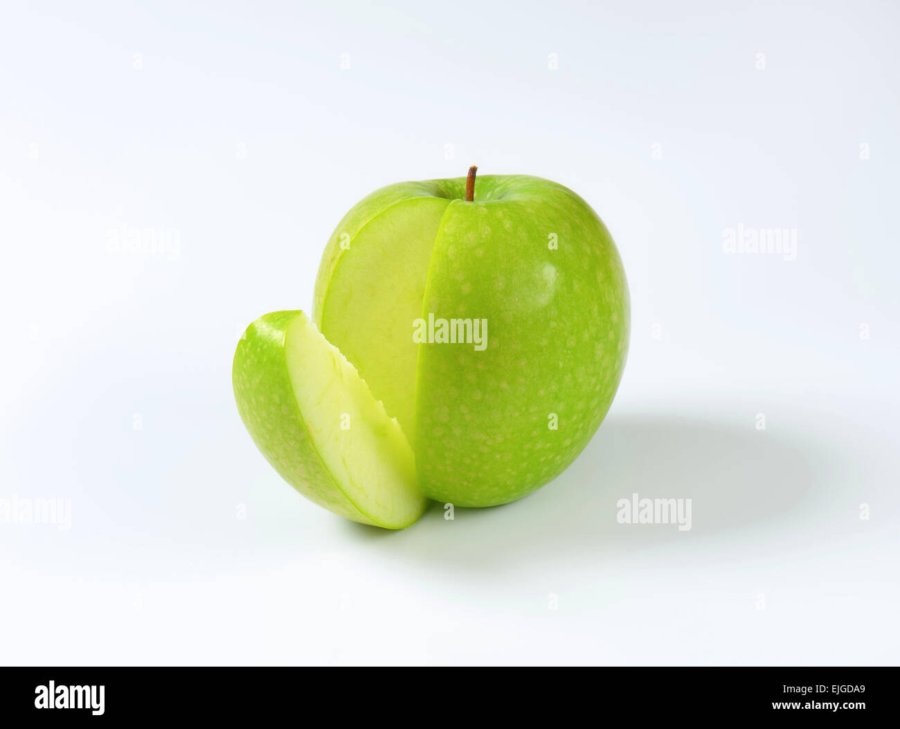 Green apple - a wedge cut off Stock Photo - Alamy