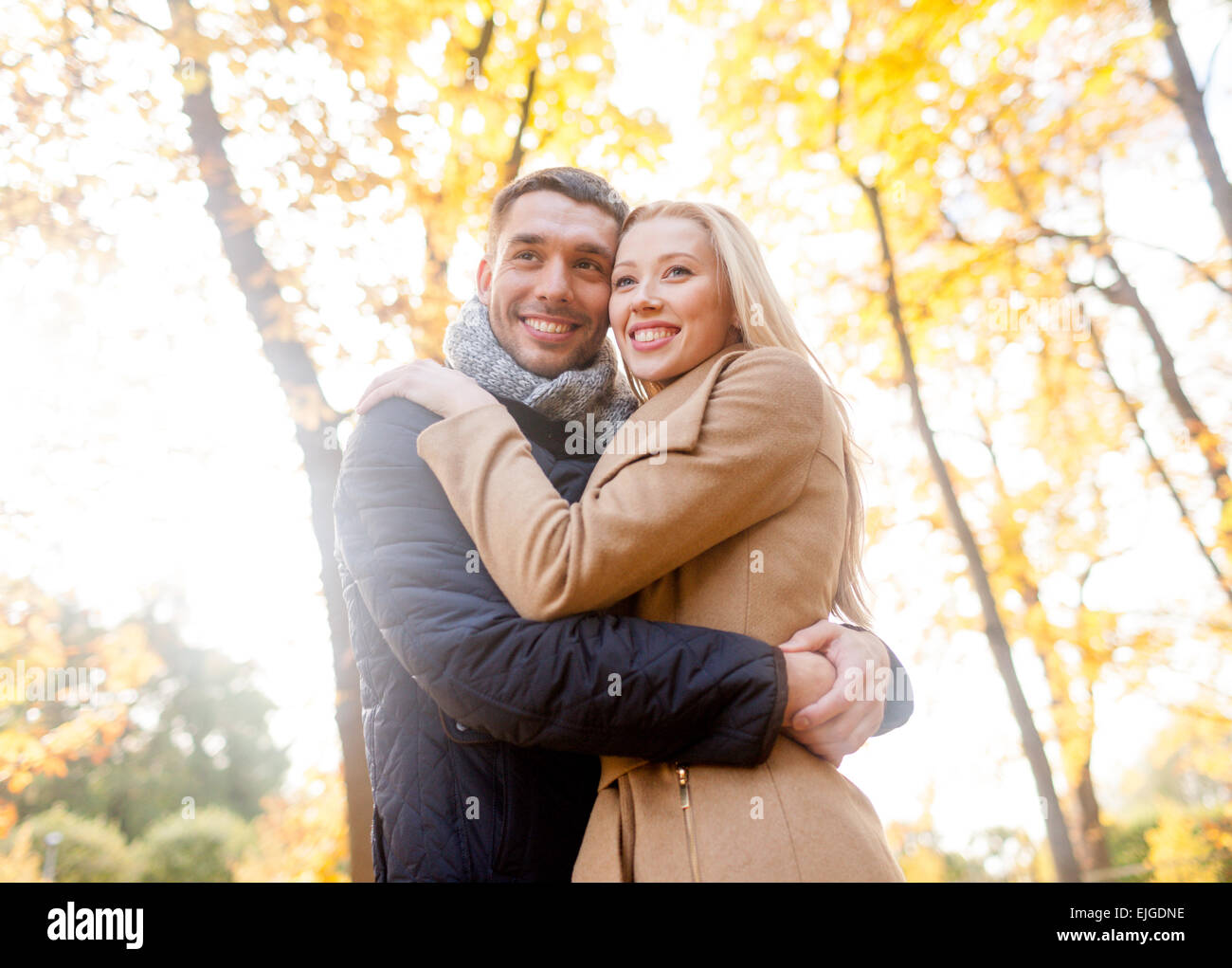 smiling couple hugging in autumn park Stock Photo - Alamy