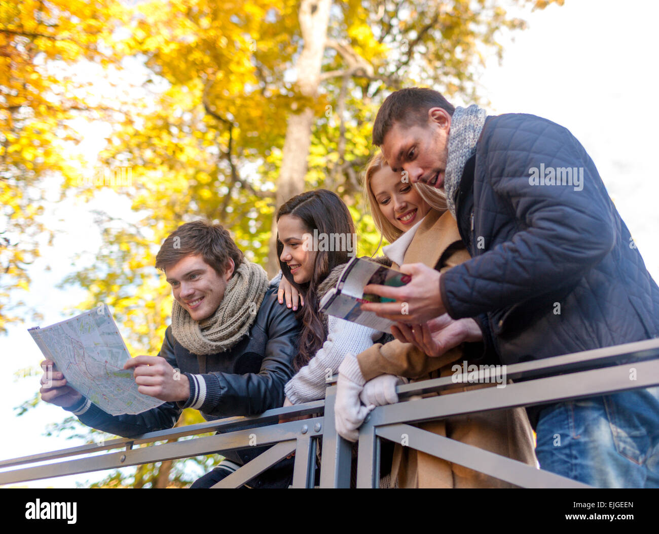 group of friends with map outdoors Stock Photo - Alamy