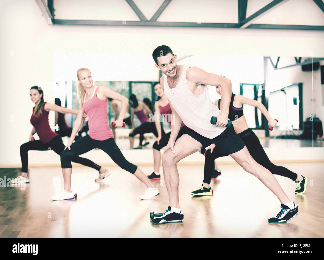 group of smiling people working out with dumbbells Stock Photo - Alamy