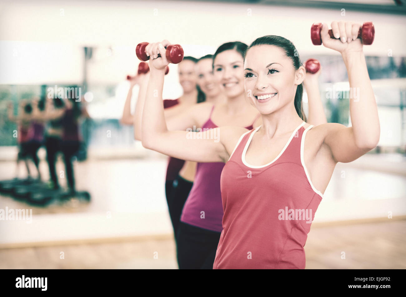group of smiling people working out with dumbbells Stock Photo - Alamy