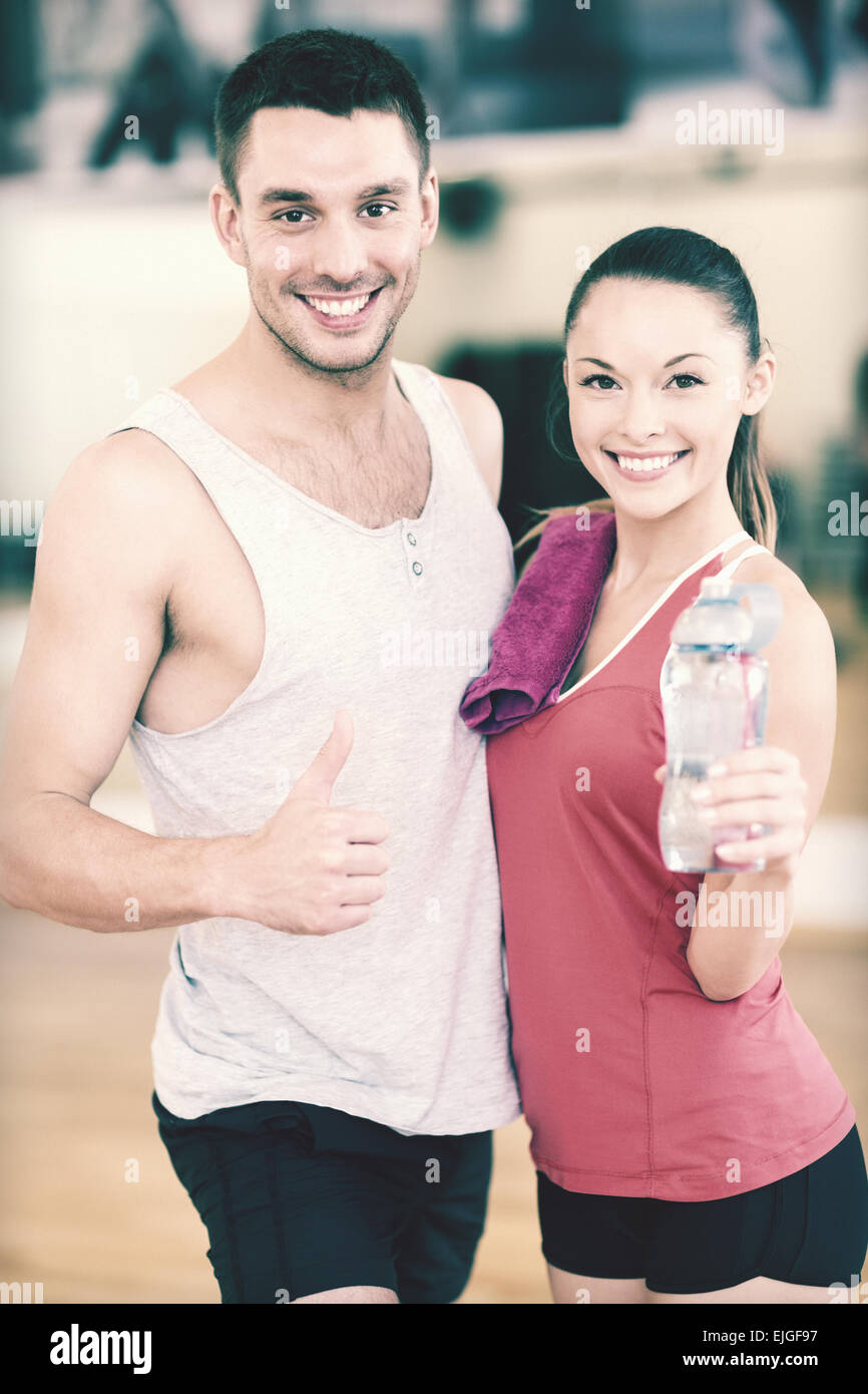 two smiling people in the gym Stock Photo - Alamy