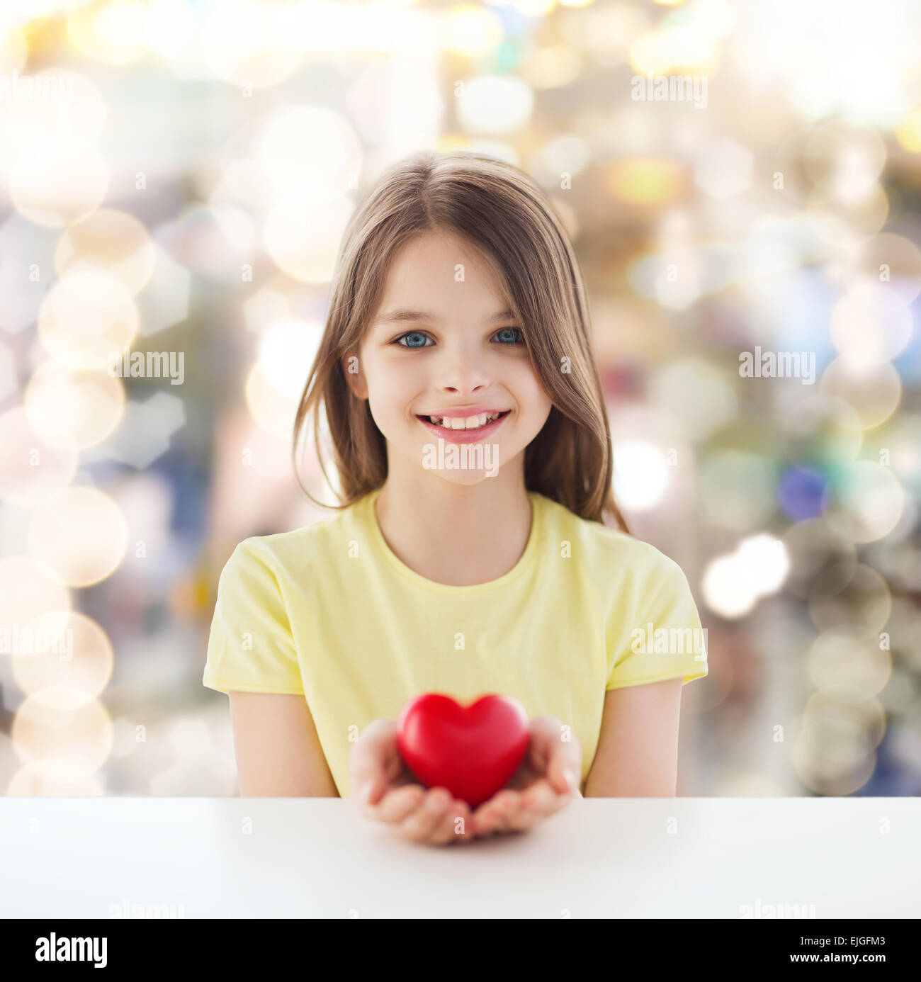 beautiful little girl sitting at table Stock Photo - Alamy