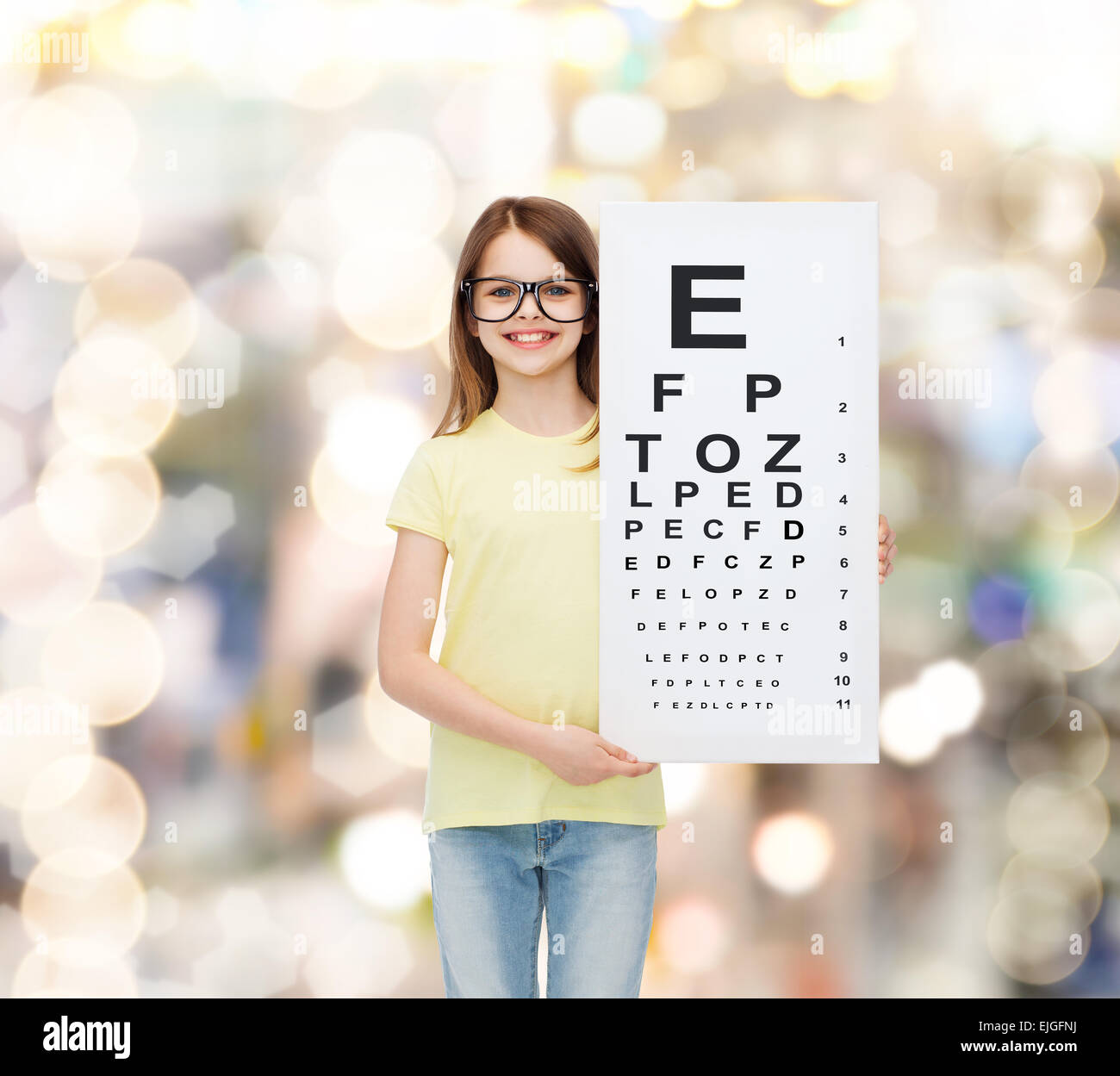little girl in eyeglasses with eye checking chart Stock Photo - Alamy