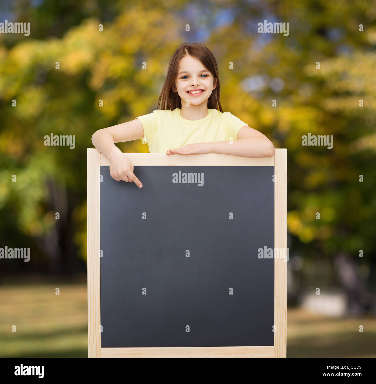 happy little girl pointing finger to blackboard Stock Photo - Alamy