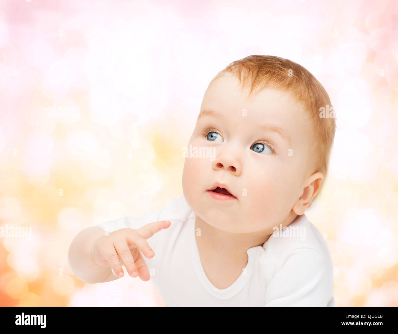 curious baby lying on floor and looking side Stock Photo - Alamy