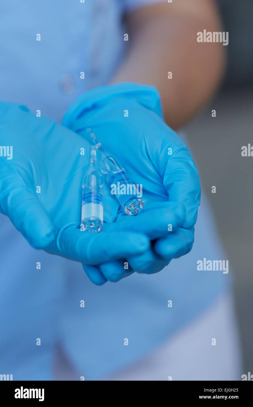 female doctor holding a vial Stock Photo - Alamy