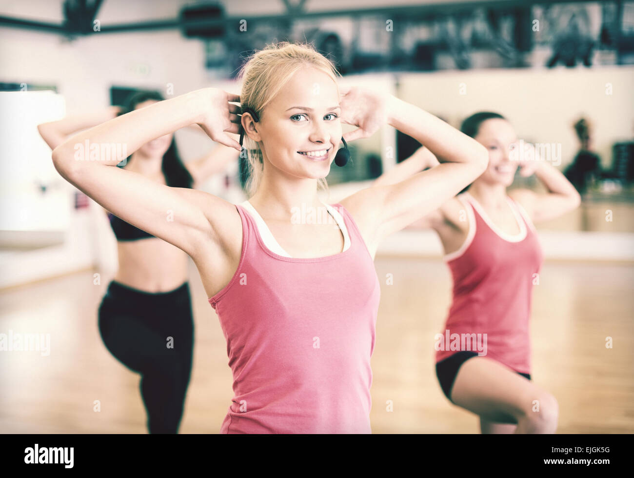 group of smiling people exercising in the gym Stock Photo - Alamy