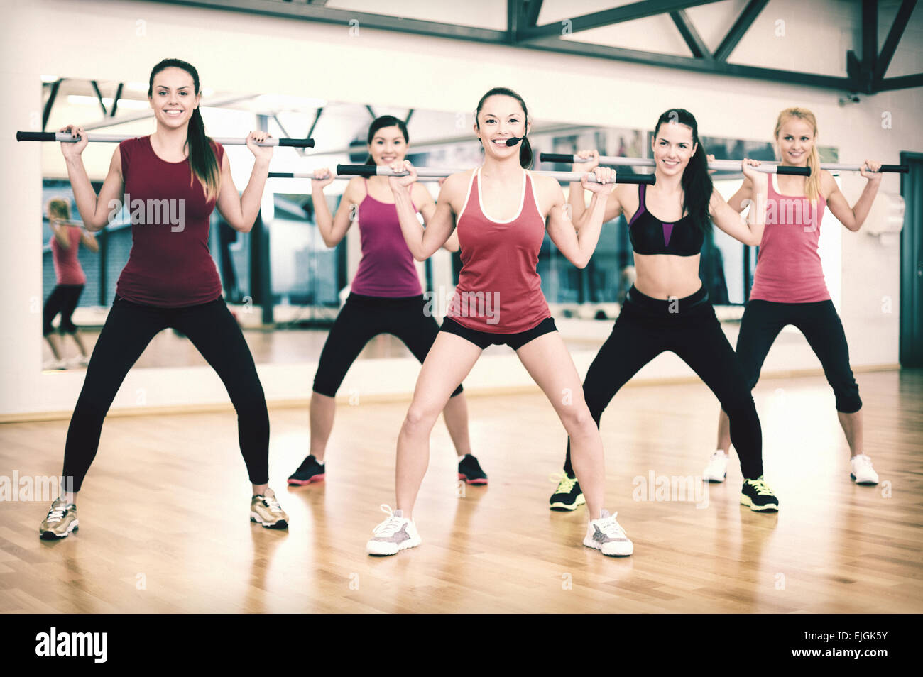 group of smiling people working out with barbells Stock Photo - Alamy