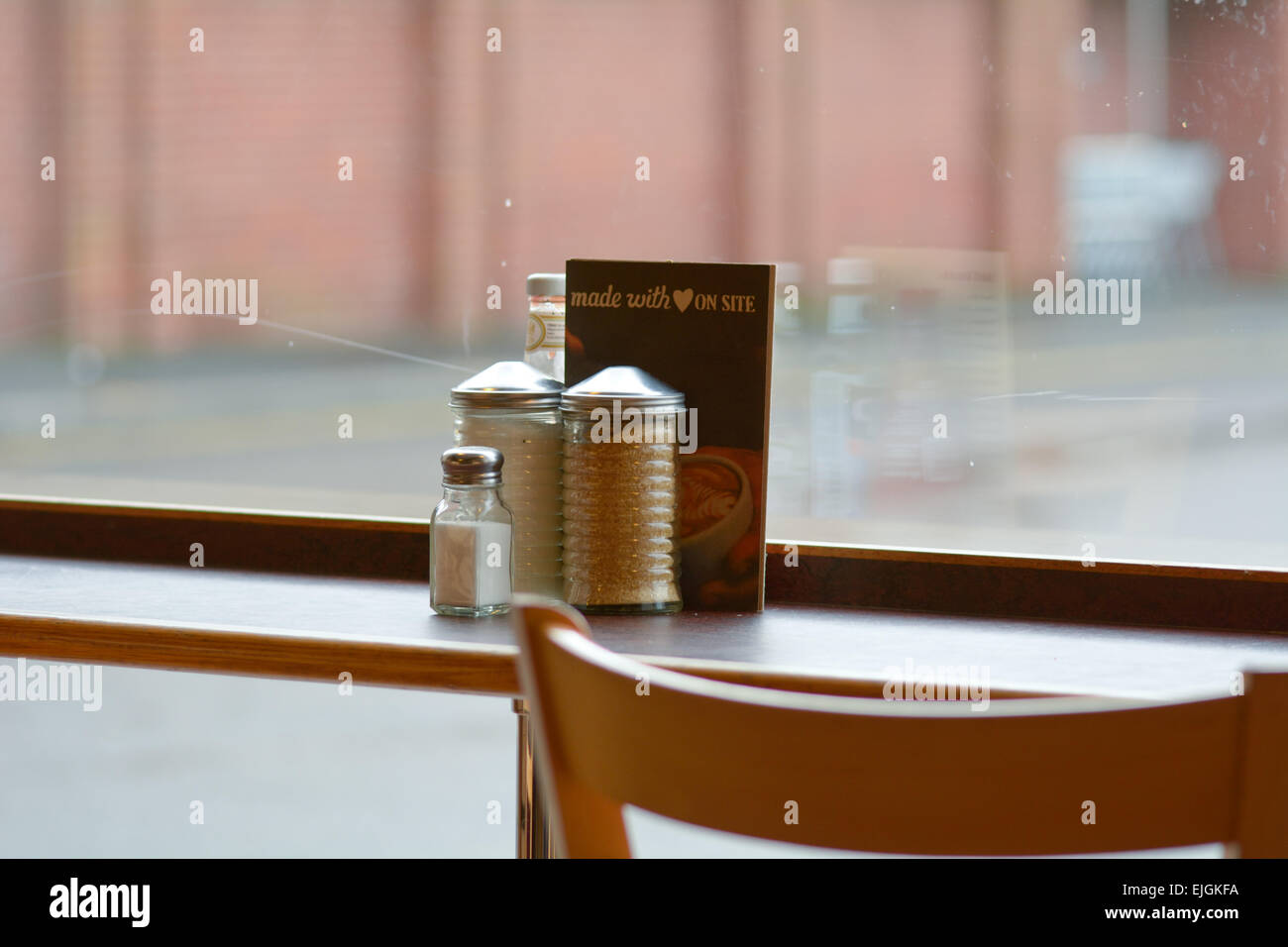 Cafe condiments on window sill Stock Photo - Alamy