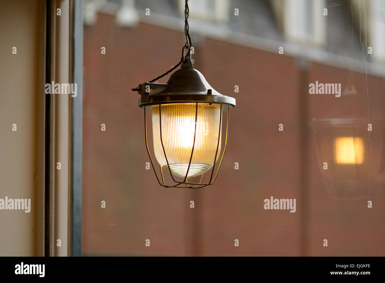 Light fitting in cafe window with reflection Stock Photo - Alamy