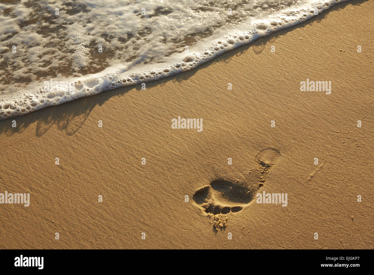 trace of a human foot on a sandy beach Stock Photo - Alamy