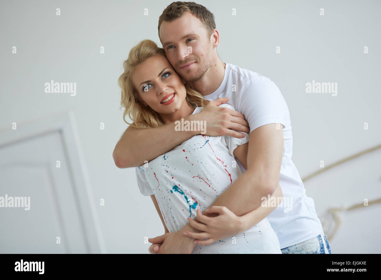 couple standing embracing Stock Photo - Alamy