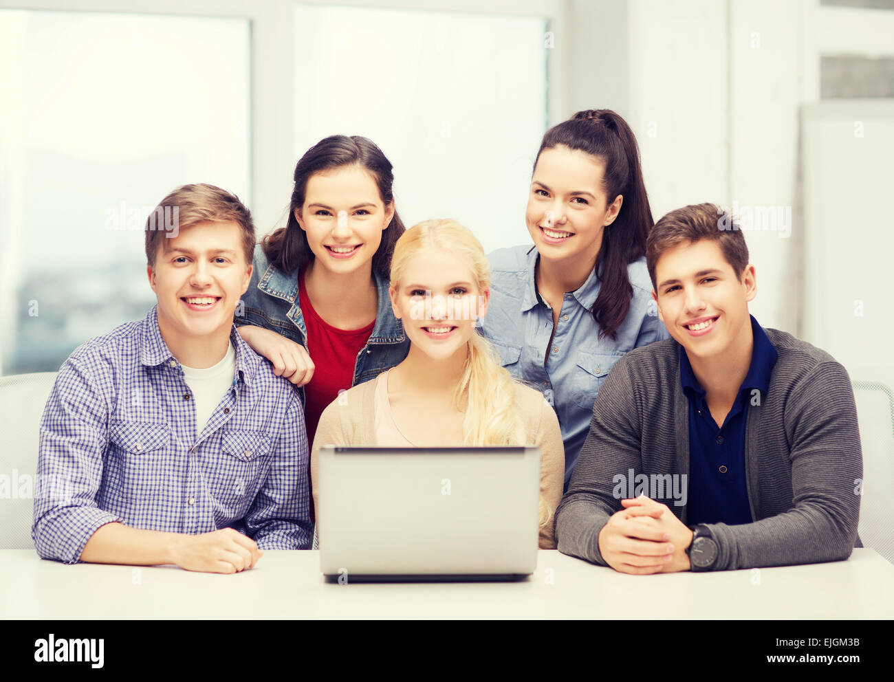 smiling students with laptop at school Stock Photo - Alamy