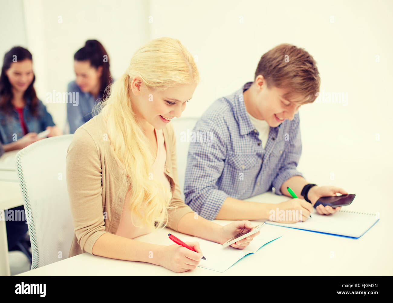 smiling students with notebooks at school Stock Photo - Alamy