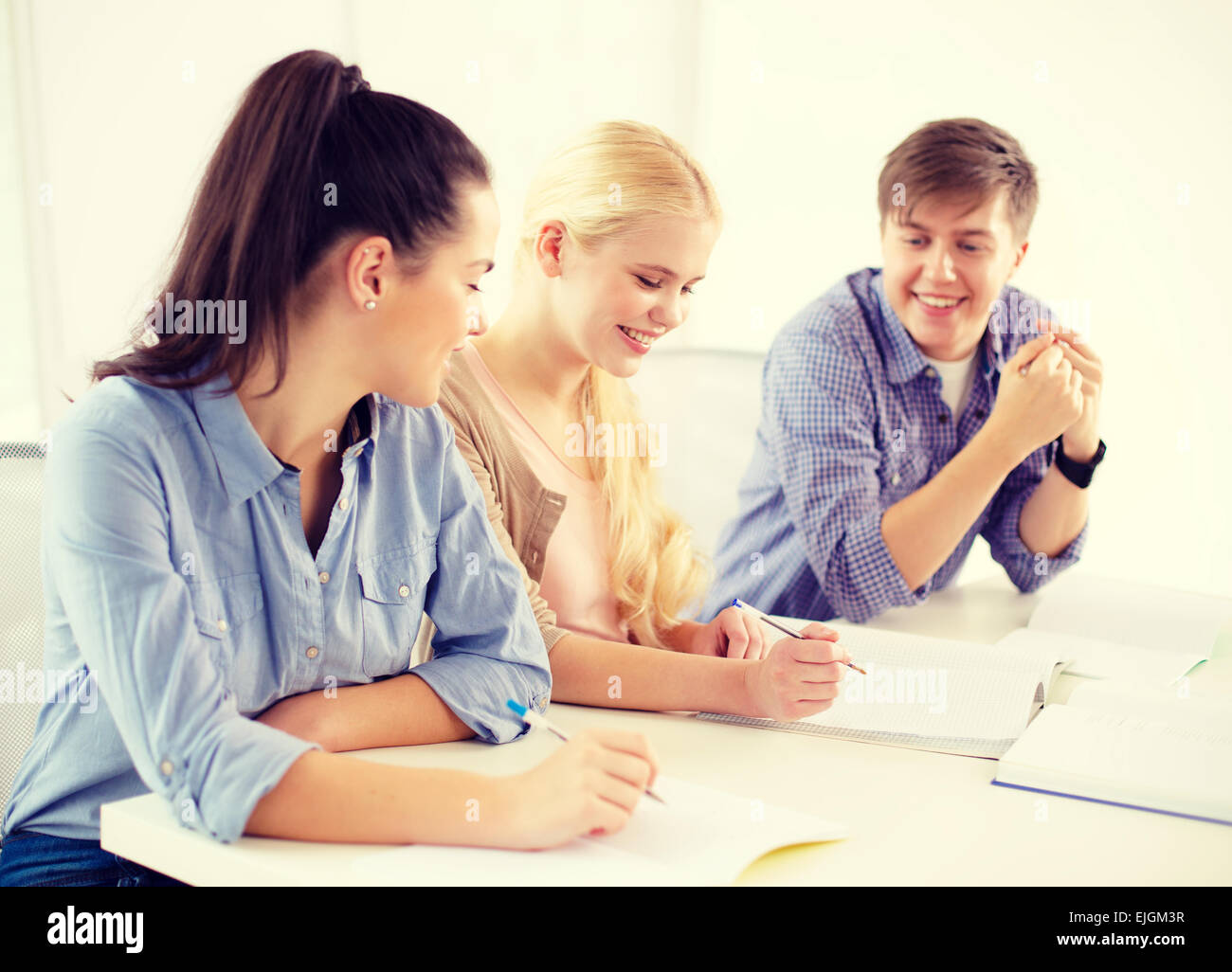 smiling students with notebooks at school Stock Photo - Alamy