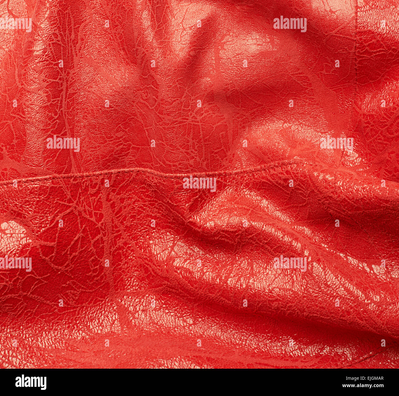 Artificial red leather material fragment Stock Photo - Alamy