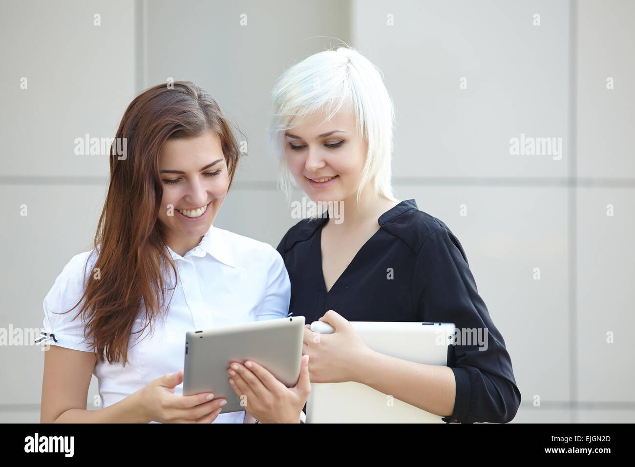 Two business woman with tablets Stock Photo - Alamy