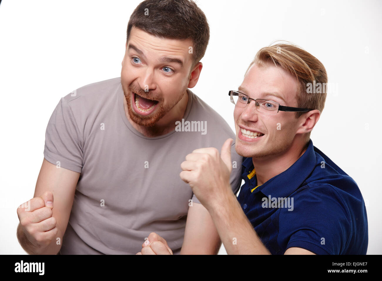 Two young men watching the competition Stock Photo - Alamy