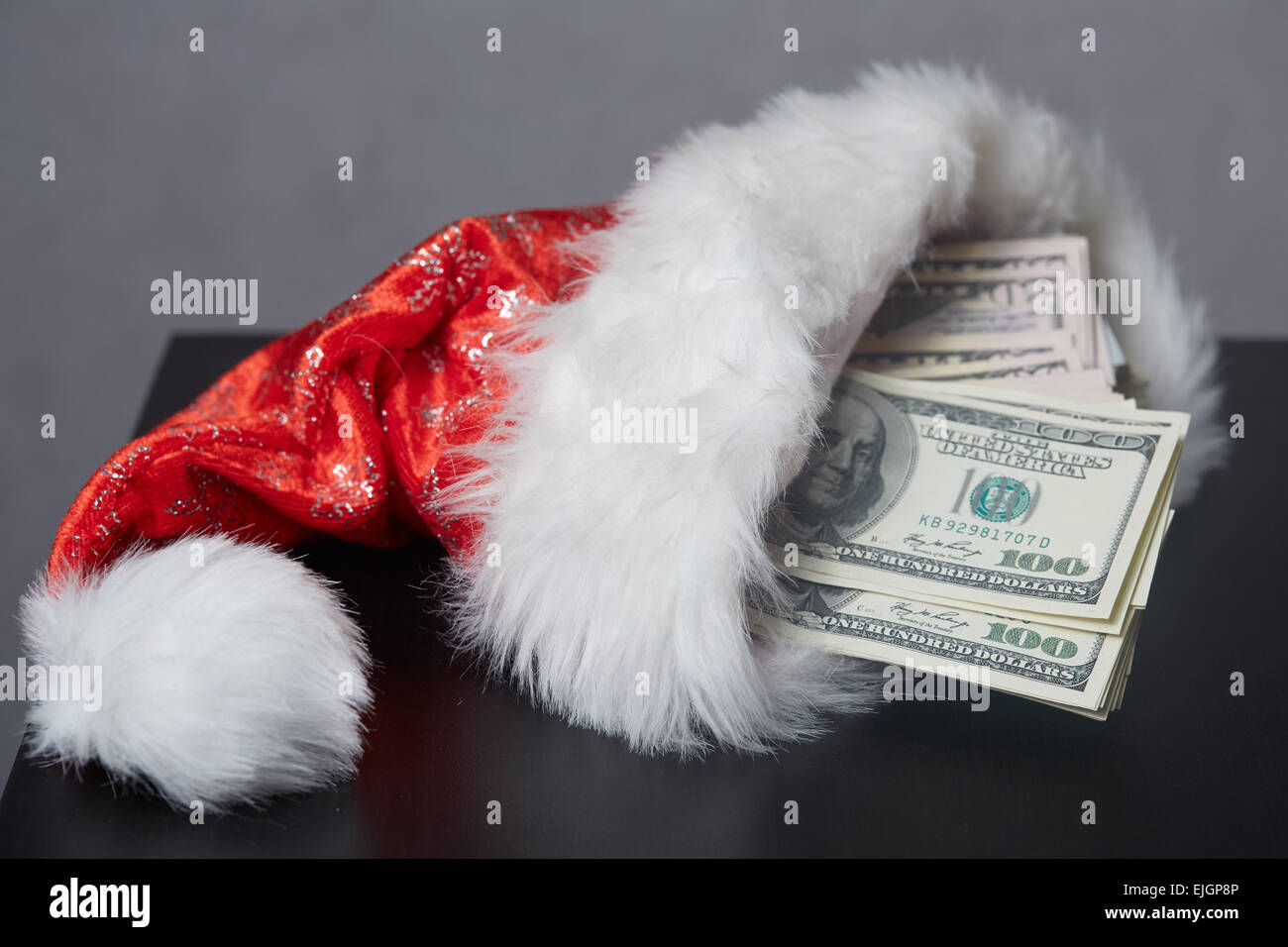money in a Christmas cap Santaklaus Stock Photo - Alamy