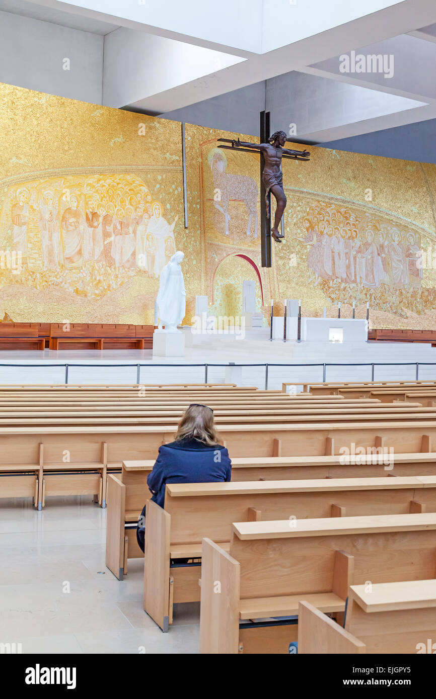 Sanctuary of Fatima, Portugal. Faithful praying inside the modern Minor ...