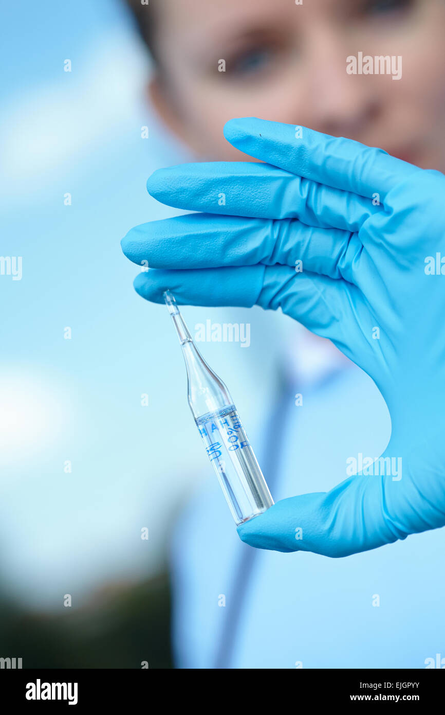 female doctor holding a vial Stock Photo - Alamy