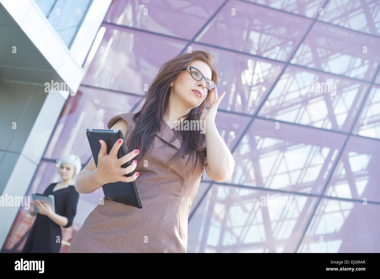 businesswomen whith tablets and phones on the street Stock Photo - Alamy