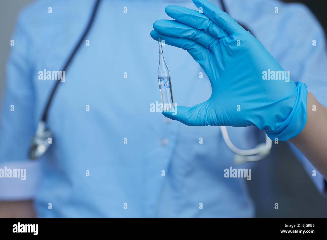female doctor holding a vial Stock Photo - Alamy