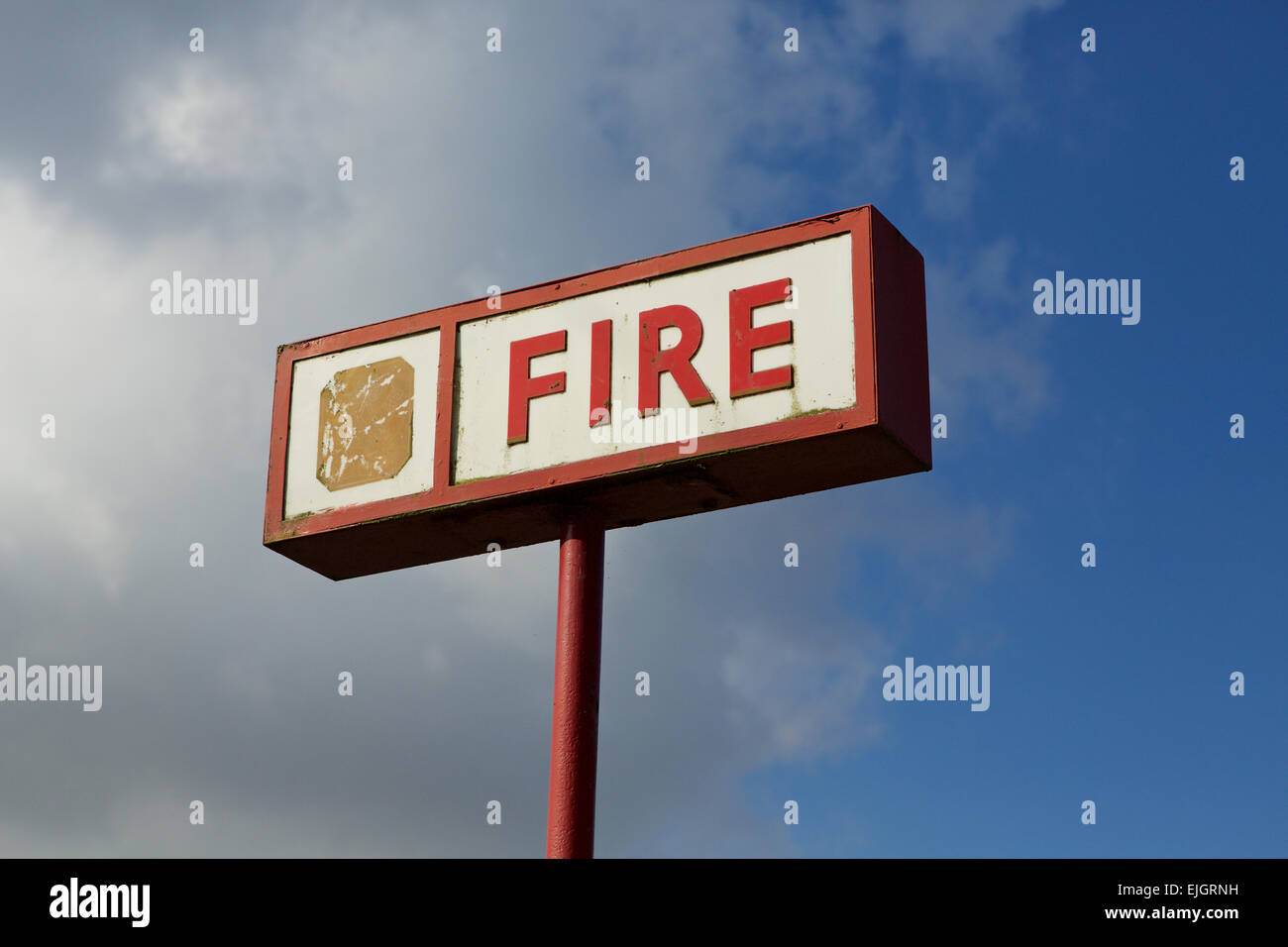 Really old fire station sign. Faded and shabby sign against a blue sky ...