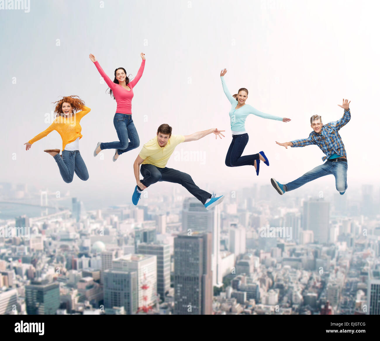 group of smiling teenagers jumping in air Stock Photo - Alamy