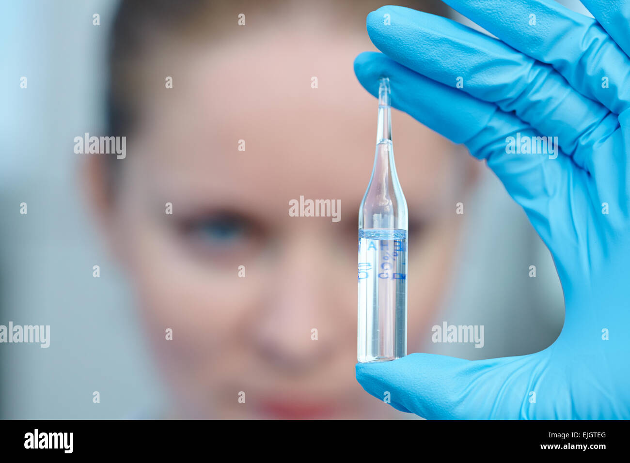 female doctor holding a vial Stock Photo - Alamy